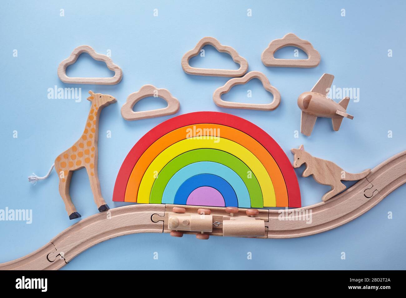 Colorful wooden toys background with rainbow. Preschool, childhood ...
