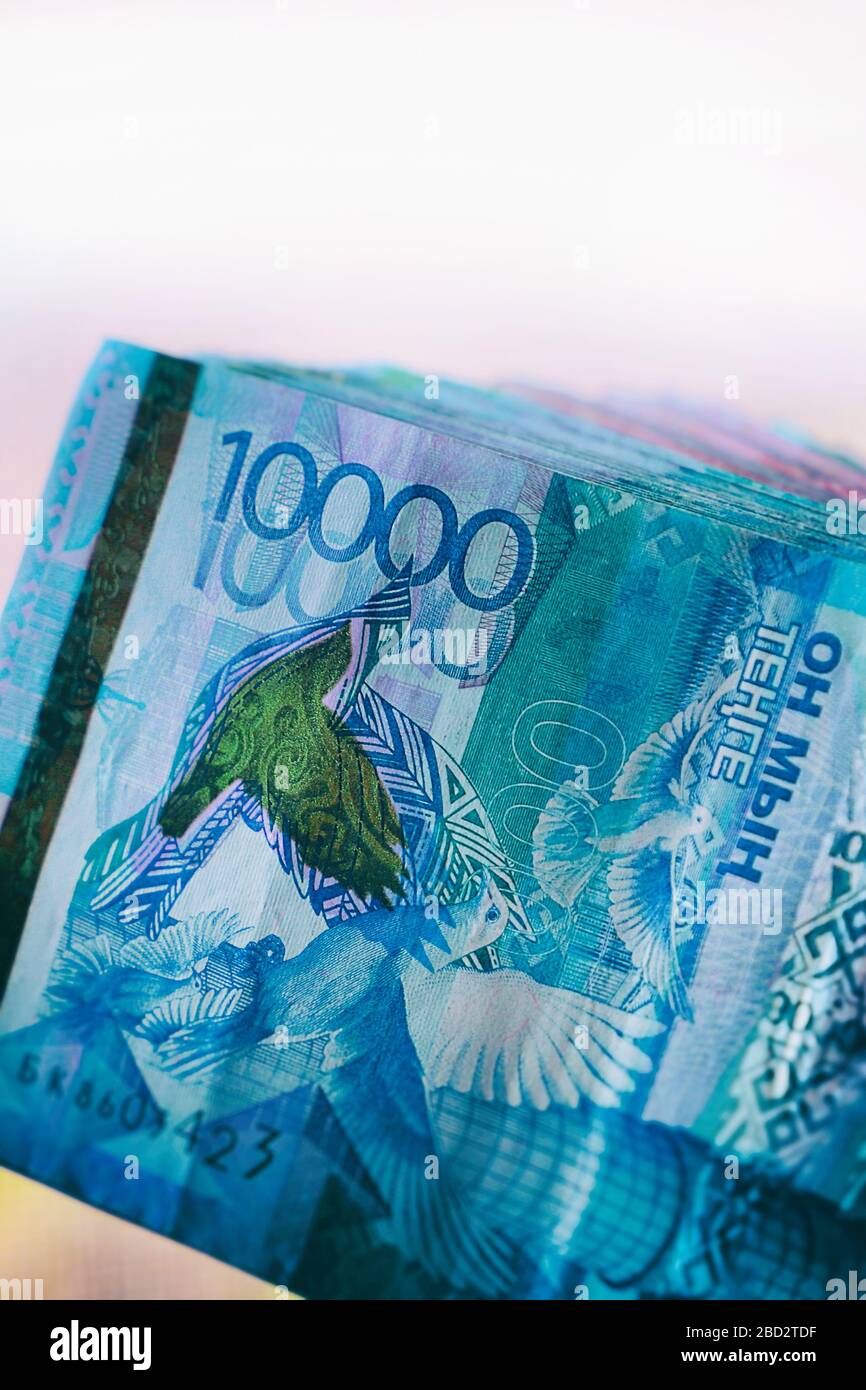 A pack of tenge money on a white background Stock Photo - Alamy