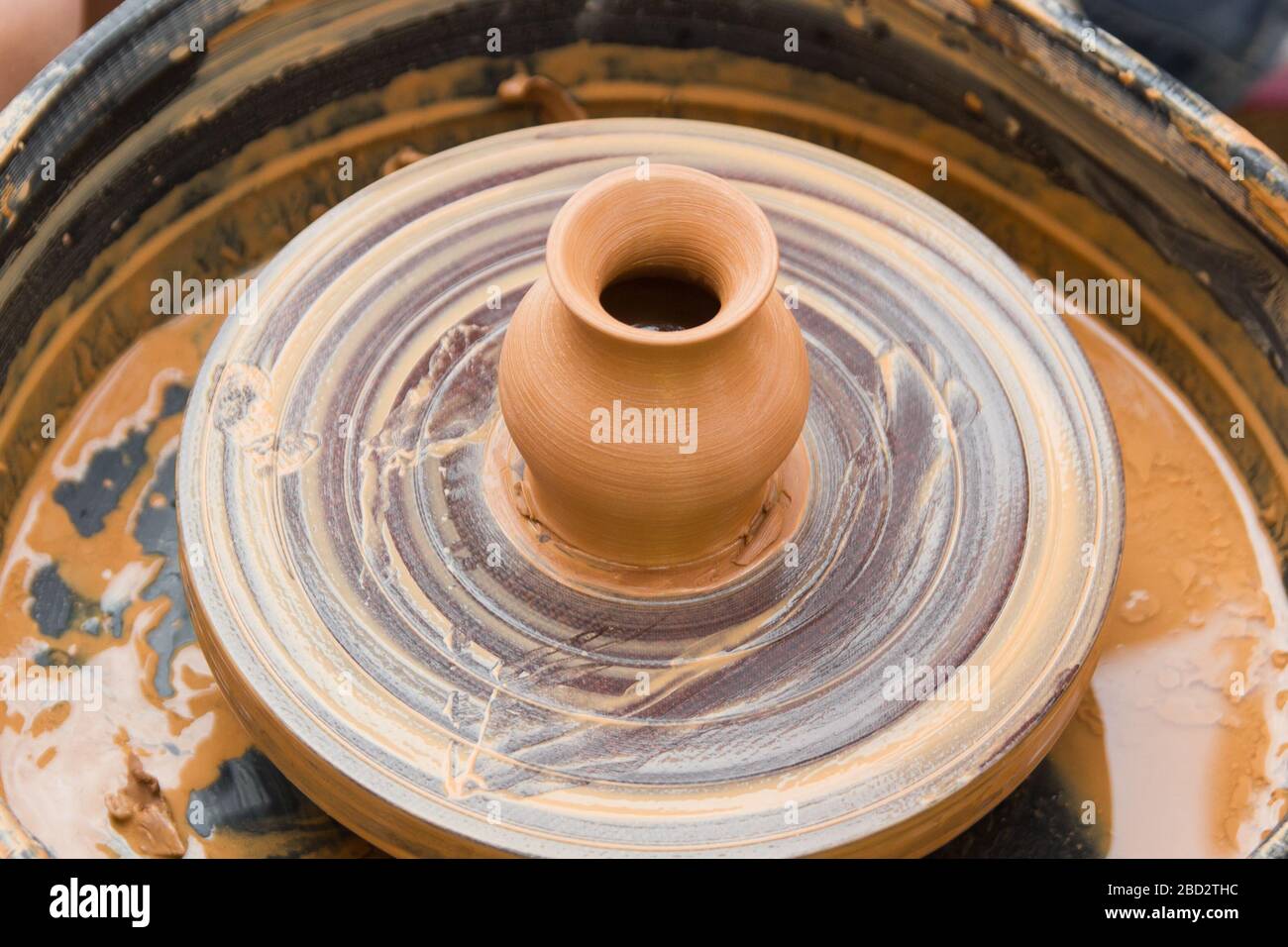 A close up view on ceramic production process on potter's wheel with ...