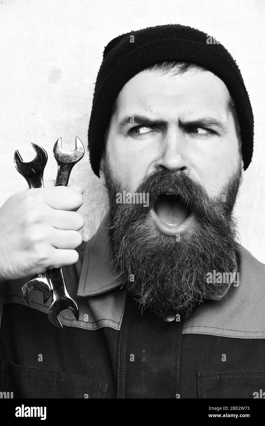 Bearded man, long beard. Brutal caucasian mechanic, surprised unshaven ...