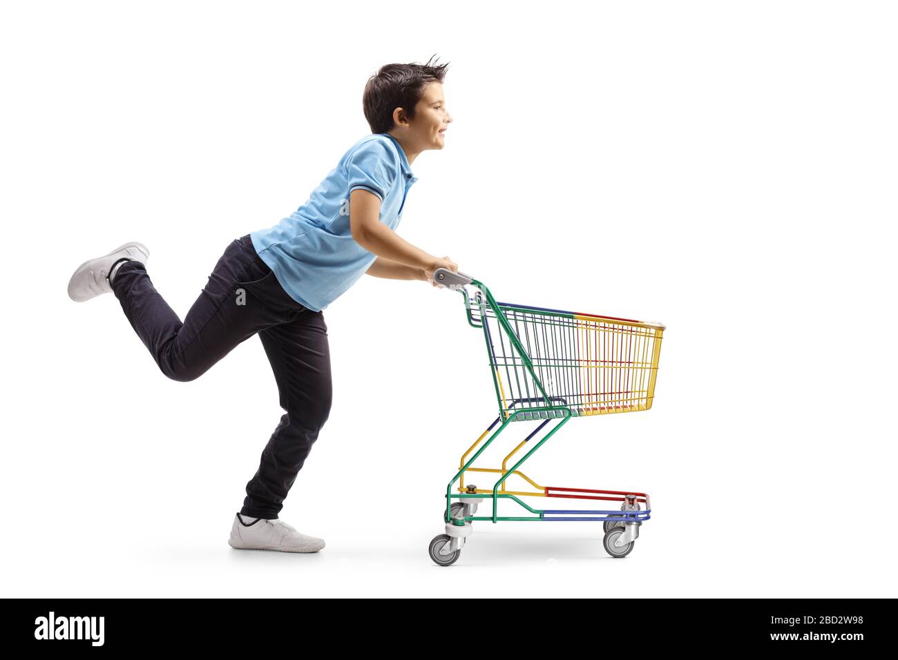 Full length profile shot of a boy running and pushing a small shopping ...