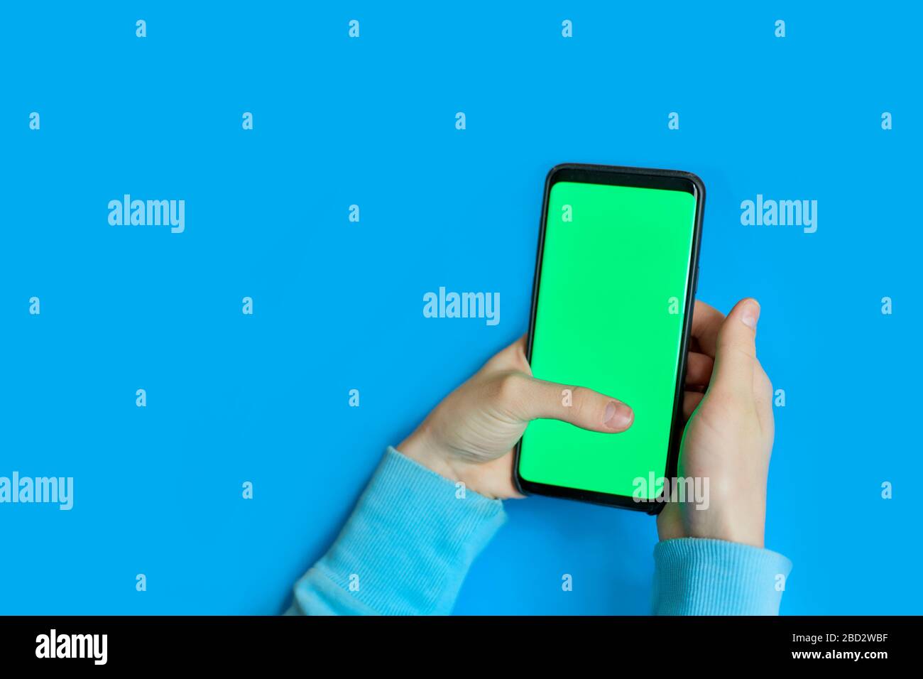 using smart phone with green screen. hands scrolling pages, tapping on ...