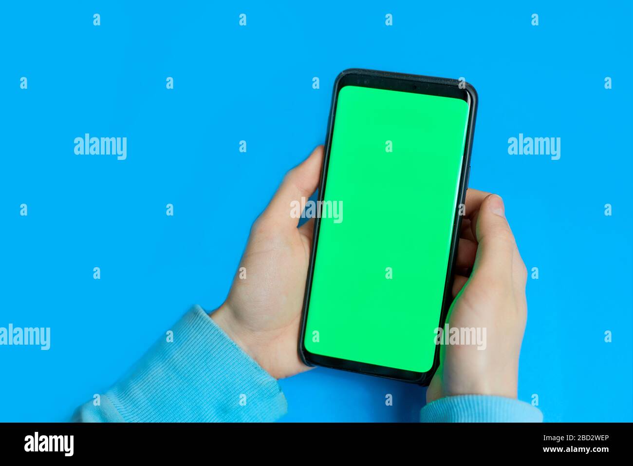 using smart phone with green screen. hands scrolling pages, tapping on ...