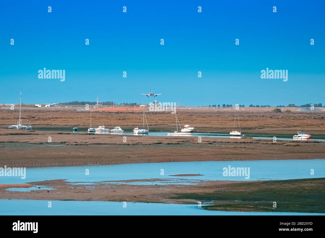 The plane flies to the airport over the river in the city of Faro in ...