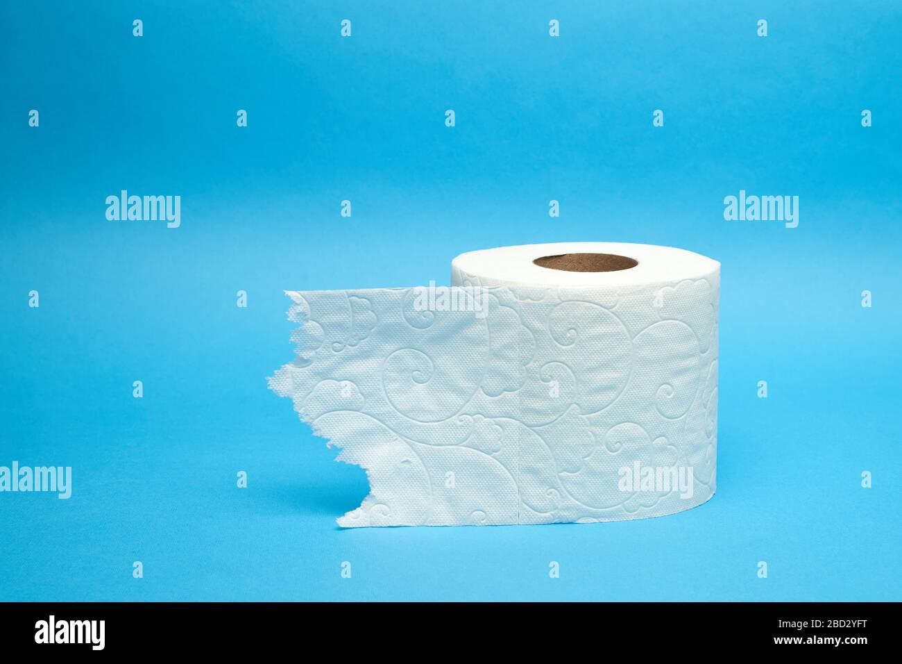 Torn off white toilet paper roll on minimalistic blue background Stock ...