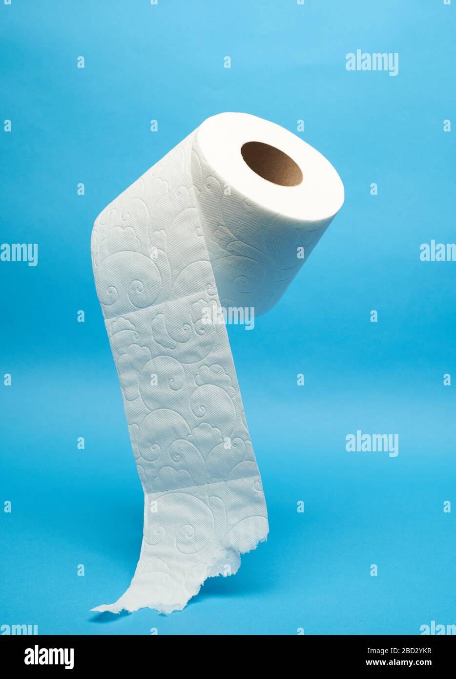 Torn off white toilet paper roll on minimalistic blue background Stock ...