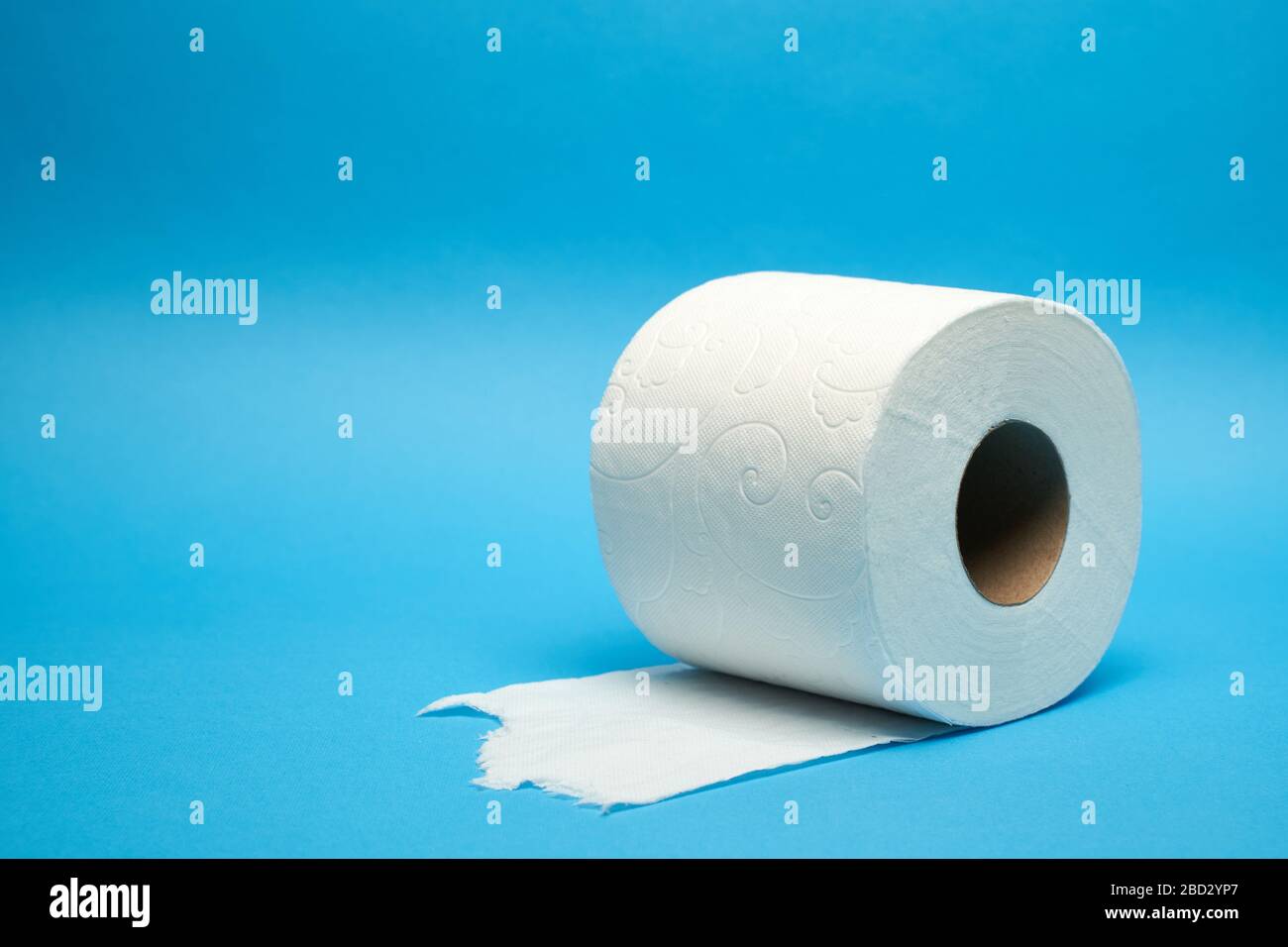 Torn off white toilet paper roll on minimalistic blue background Stock ...
