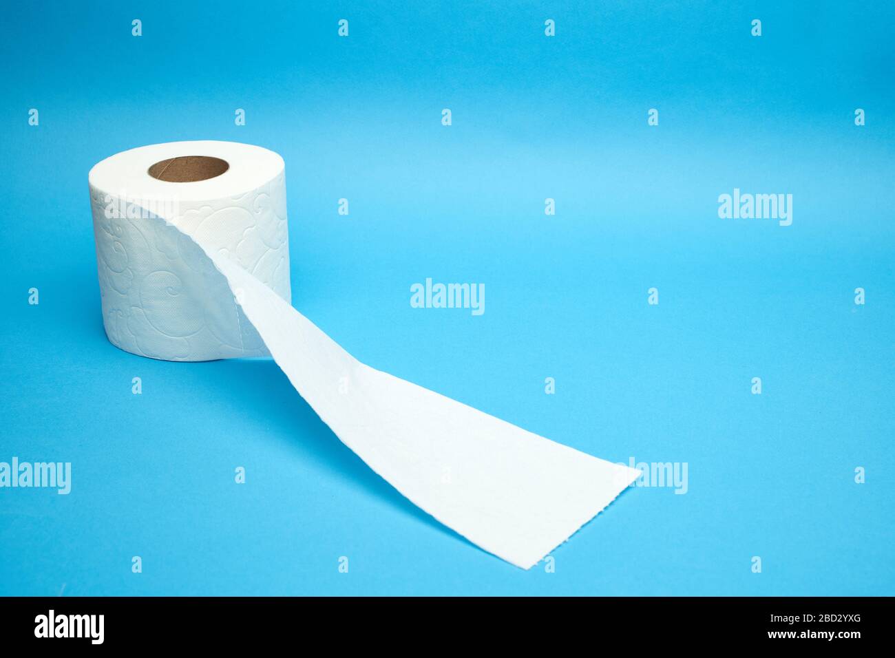 Torn off white toilet paper roll on minimalistic blue background Stock ...