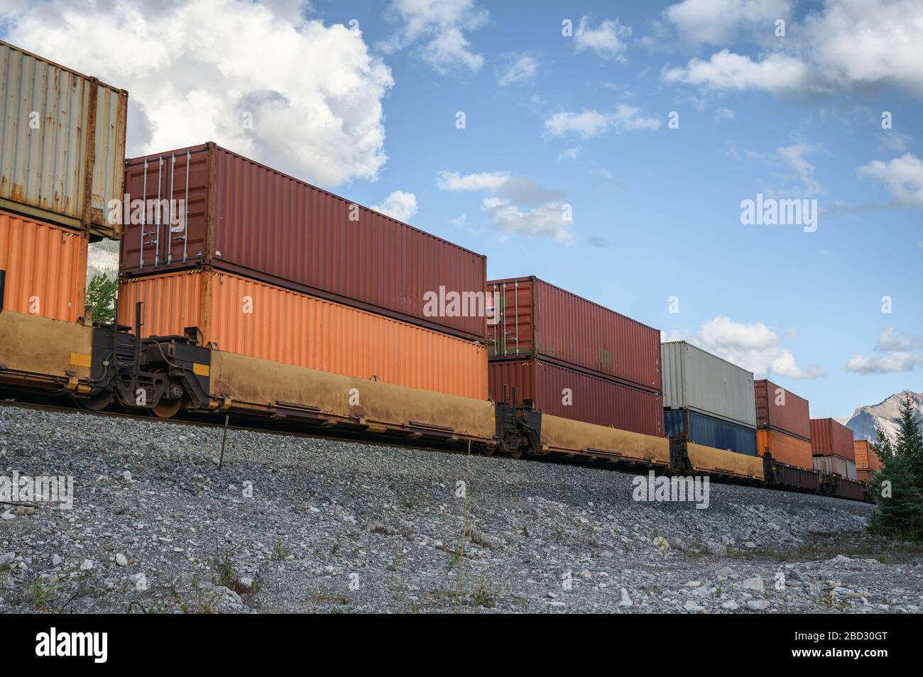 Train long freight passing with container loading on railway in valley ...