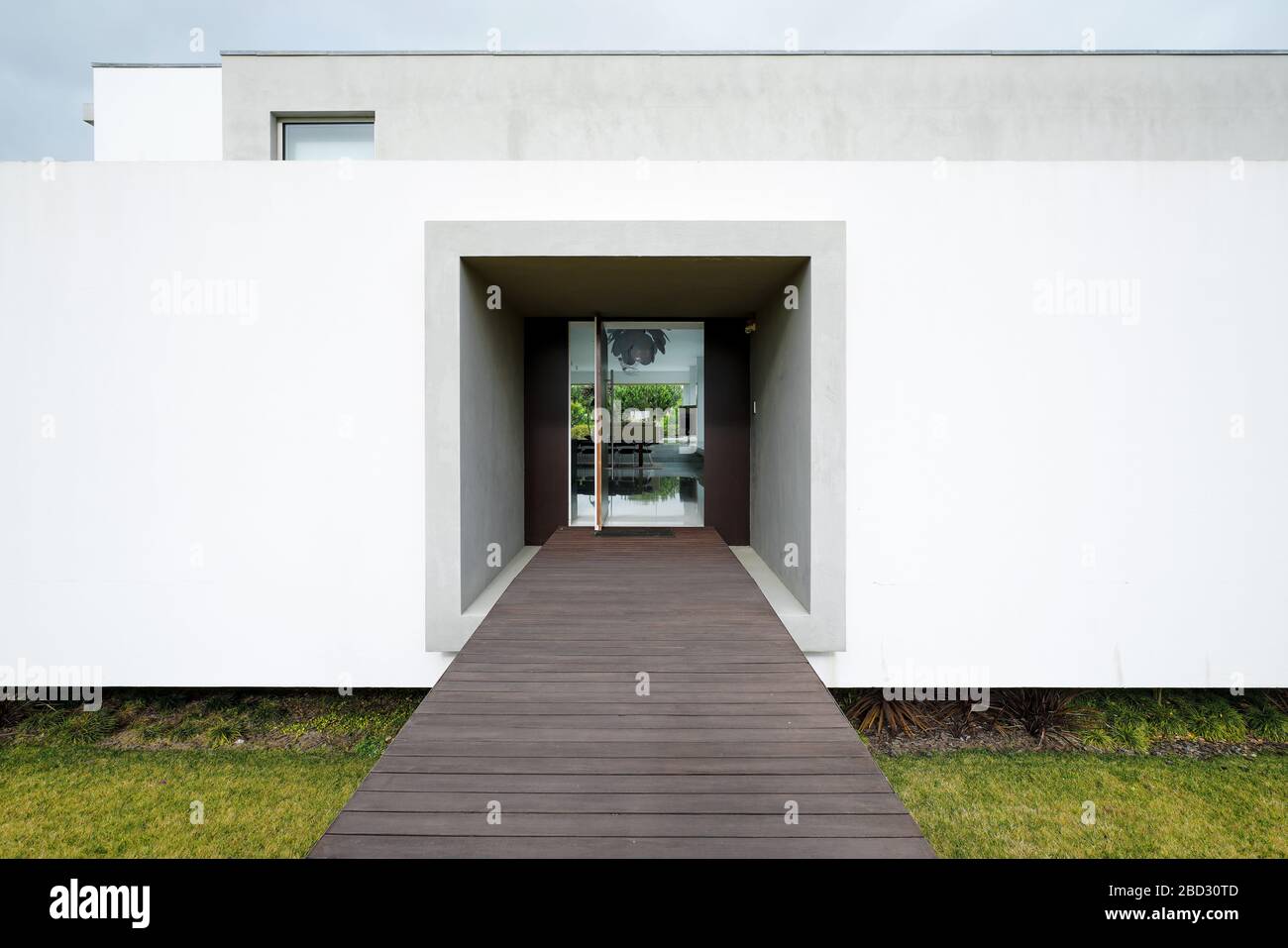 Modern house entrance with open door and access Stock Photo - Alamy