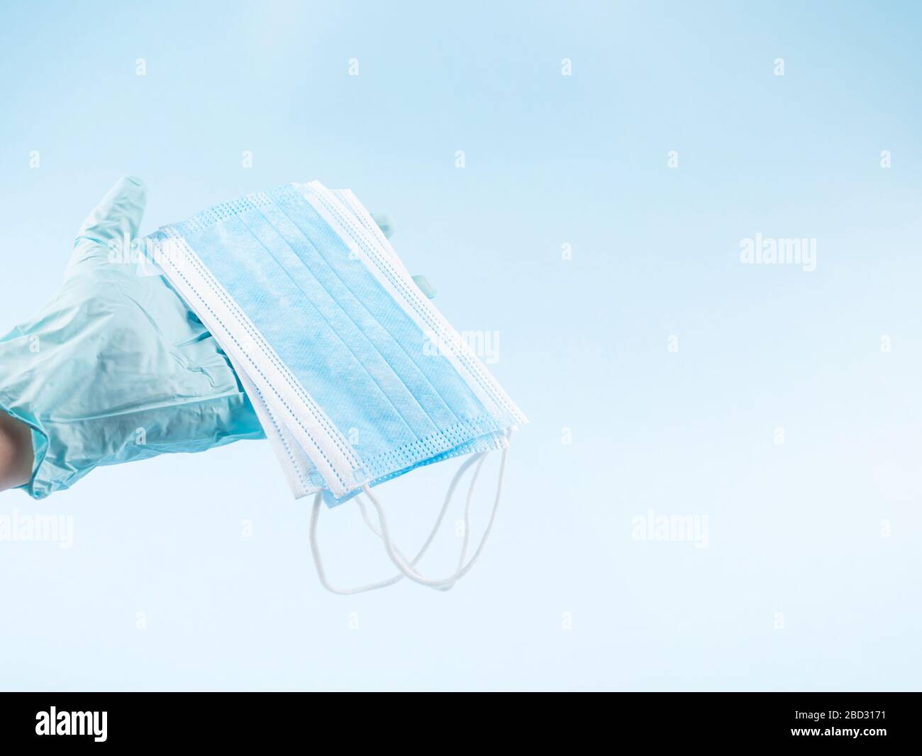 Face masks on blue as symbol of covid19 pandemic Stock Photo - Alamy