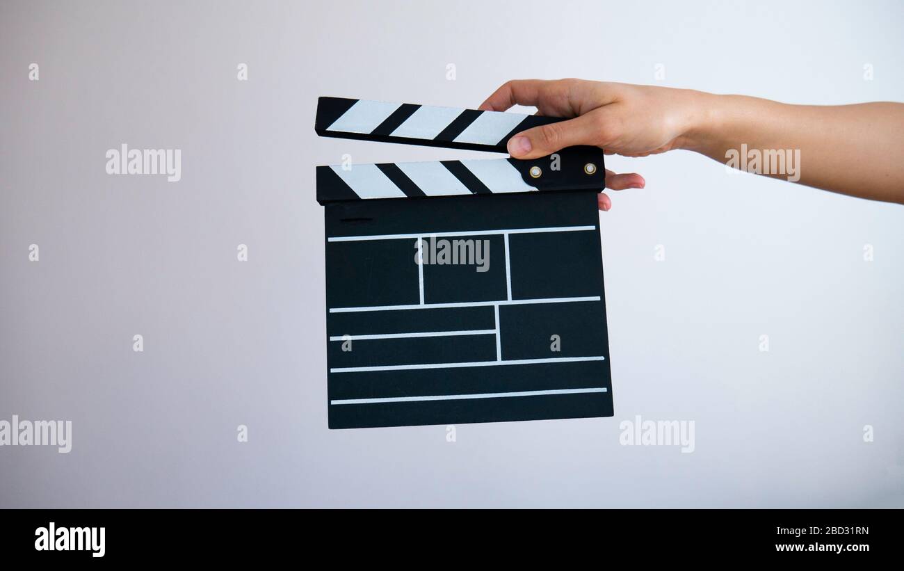 Female hand holding classic director empty film making clapperboard ...