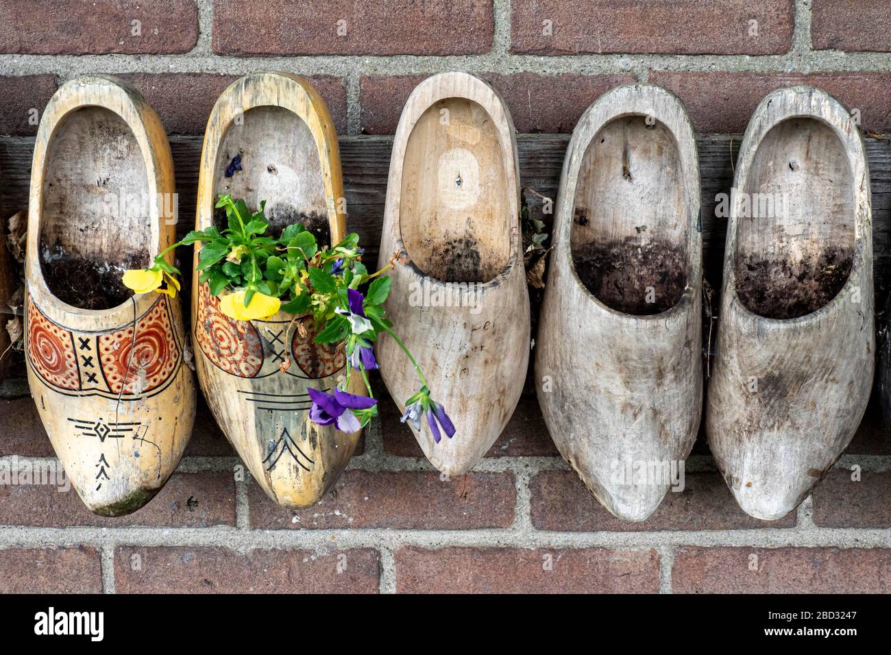 Old clogs with flower decoration on a house facade, Volendam, North ...