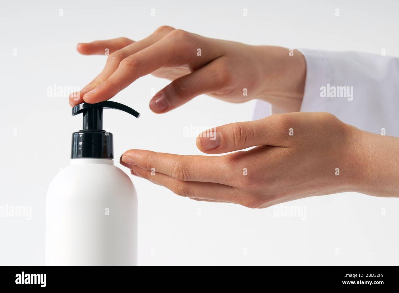 Woman hands pushing pump plastic soap bottle with copy space, using ...