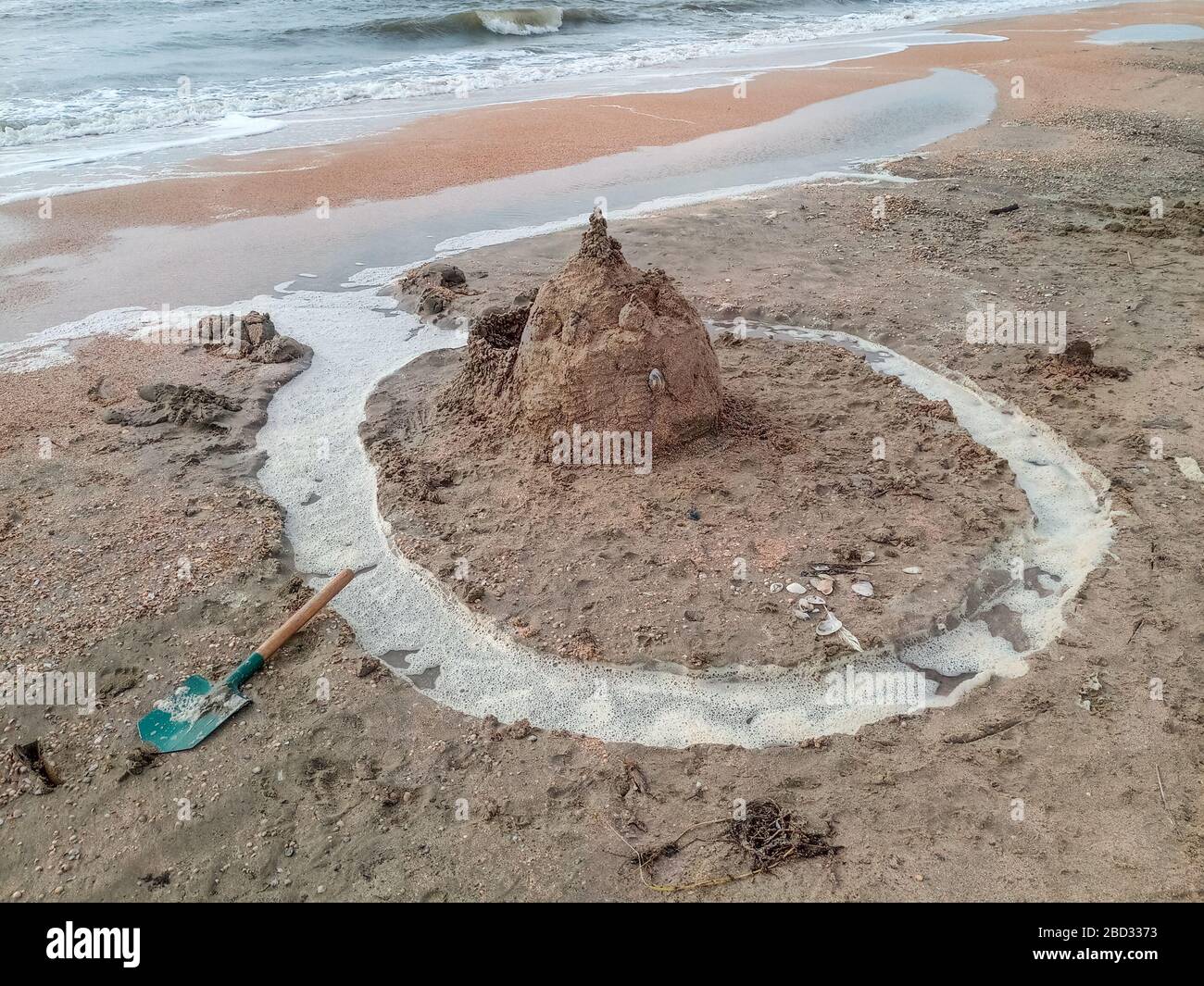 Sand castle on the beach with shells. Children's games at sea Stock ...