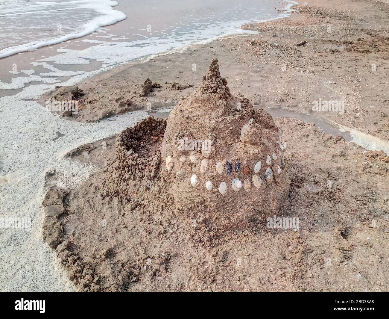 Sand castle on the beach with shells. Children's games at sea Stock ...
