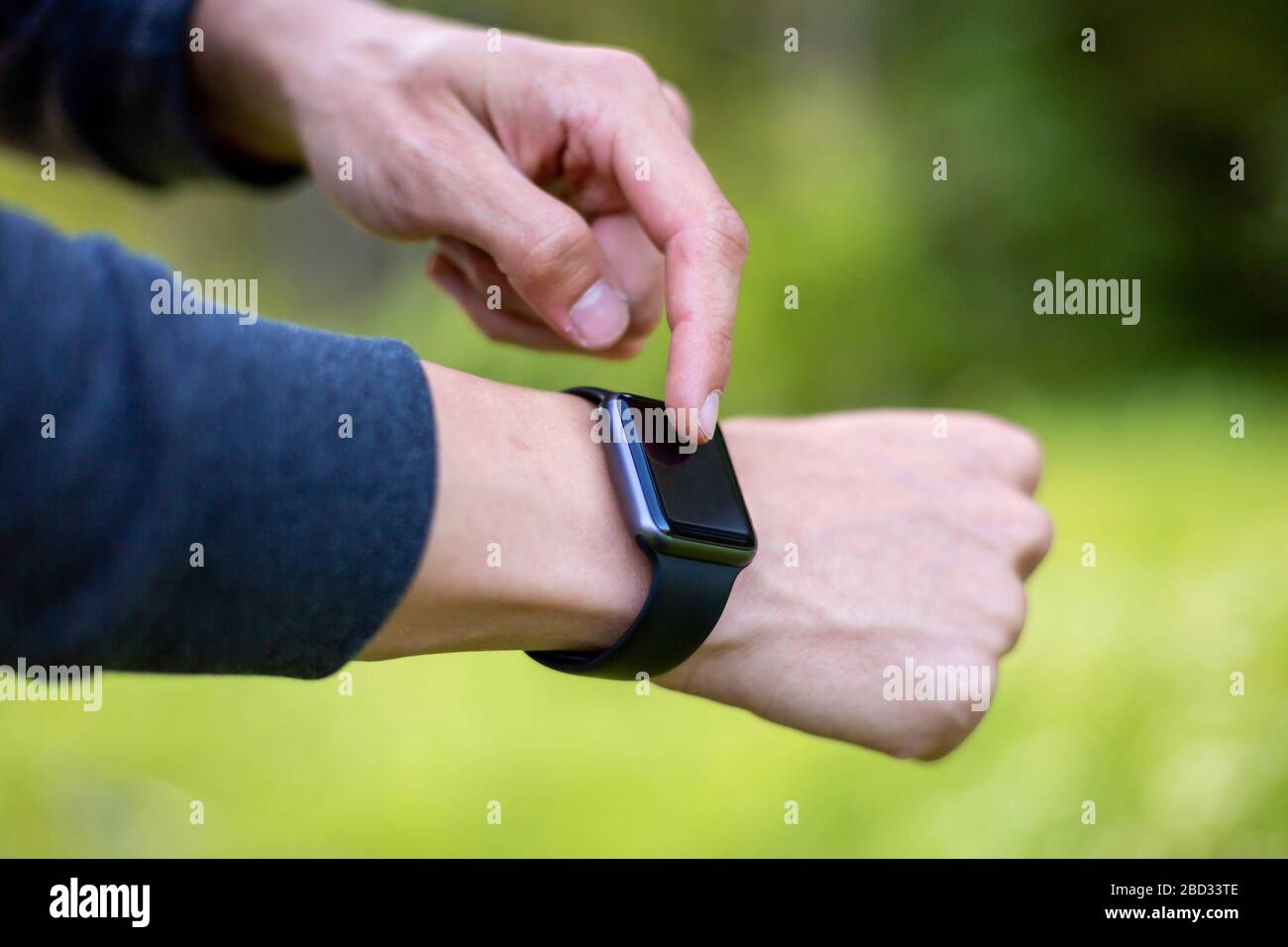 Man in nature using smartwatch app. Close-up hands Stock Photo - Alamy