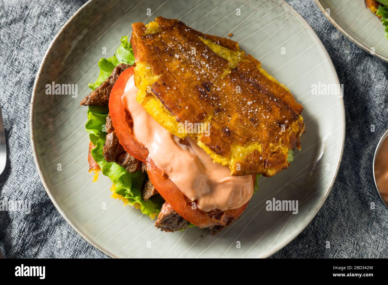 Homemade Puerto Rican Jibarito Steak Sandwich with Lettuce and Tomato ...