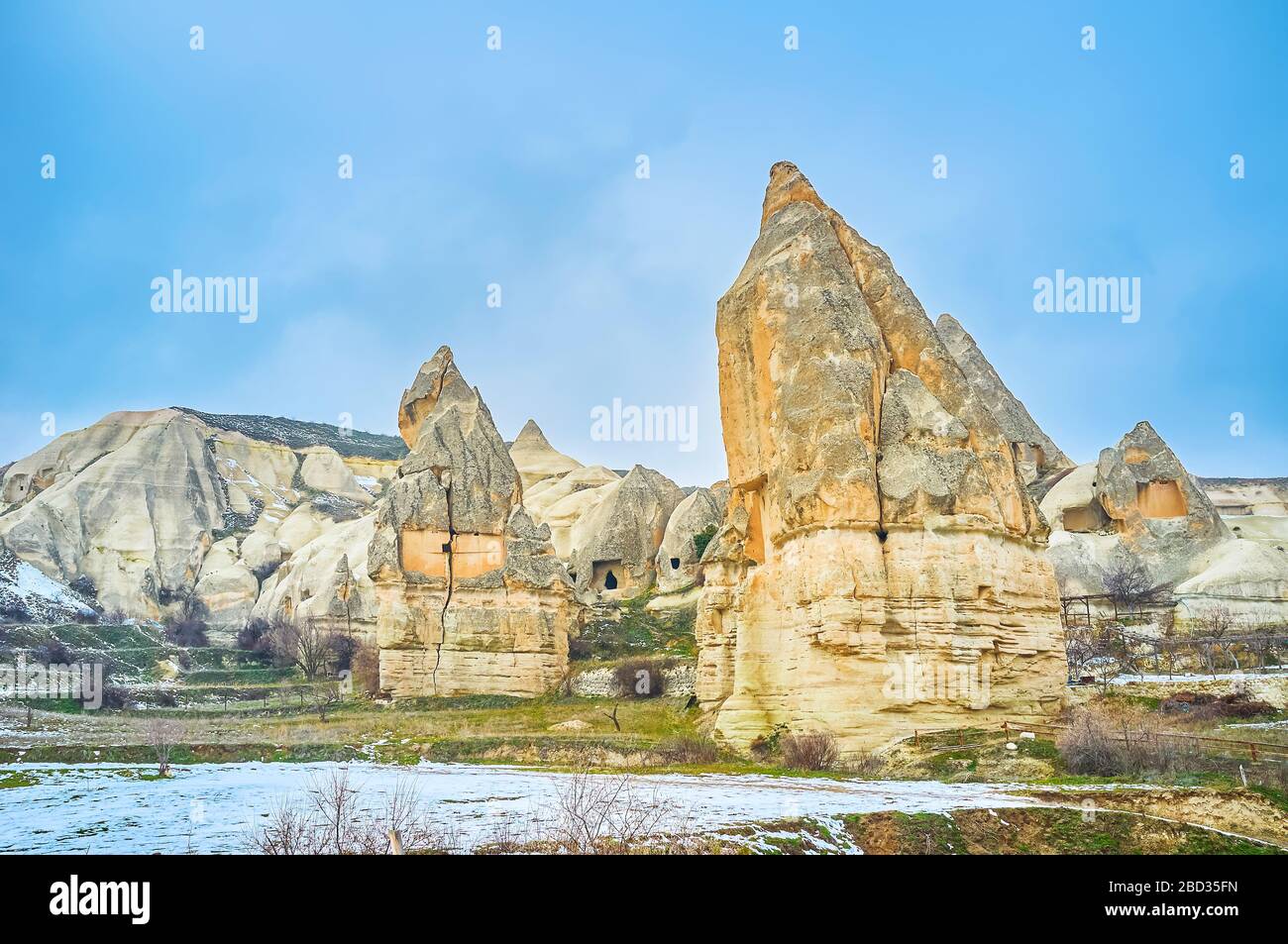 The fairy chimney rock formations of Cappadocia with ancient houses and ...