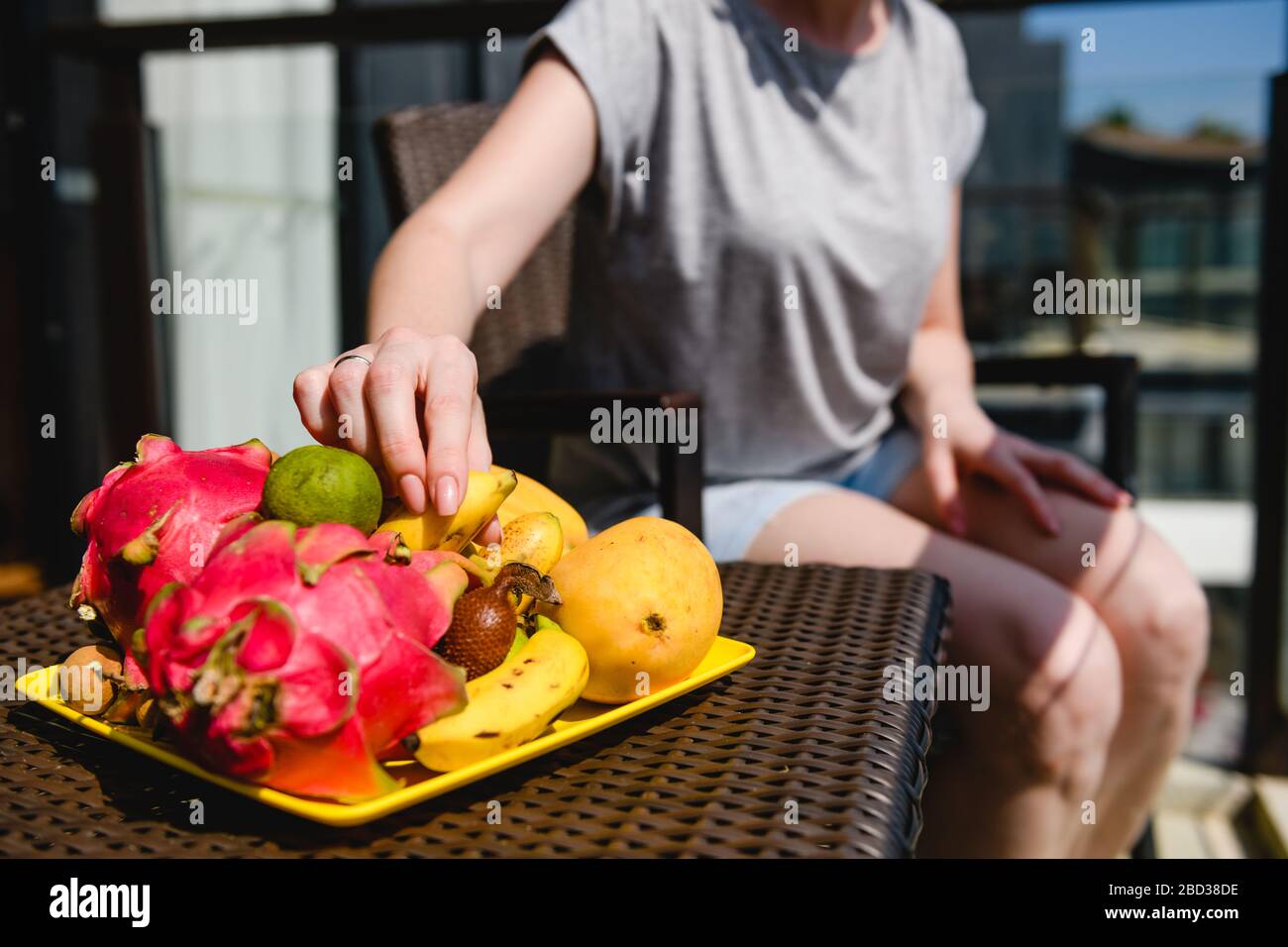 Female hand with many exotic fruits plate Stock Photo - Alamy