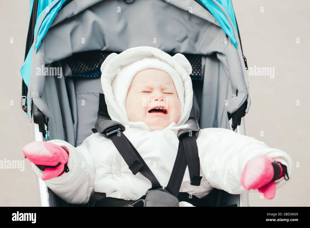 Portrait of upset crying Caucasian baby girl outside. Screaming child ...