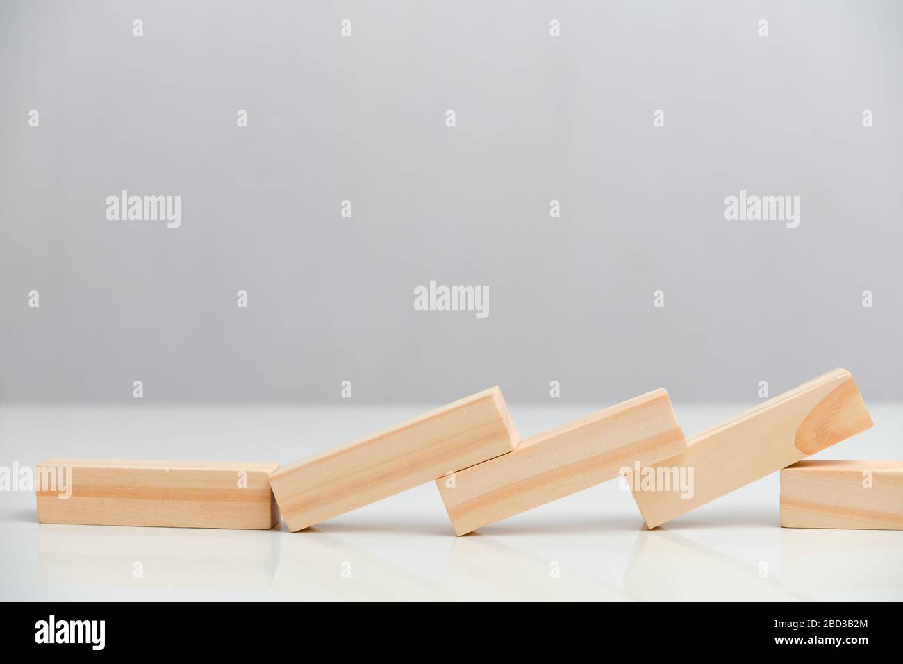 Business ruin concept. Wooden blocks on a white background background ...