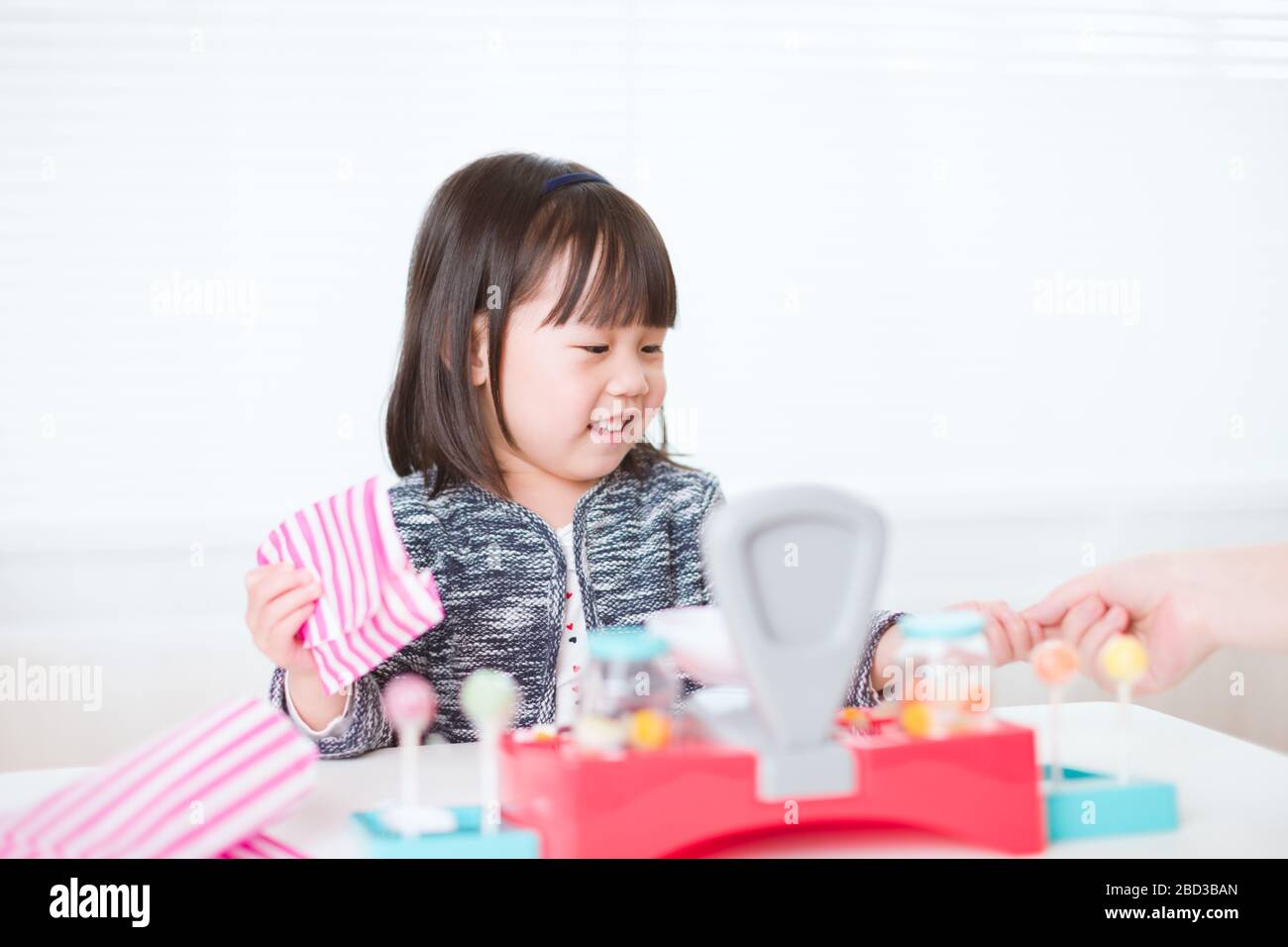 toddler girl pretend play sweet shop keeper at home Stock Photo - Alamy