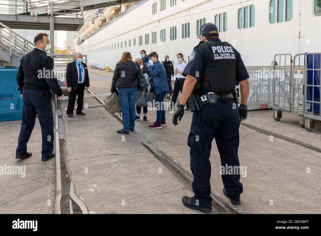 Customs and Border Patrol officers assist passengers disembarking the ...
