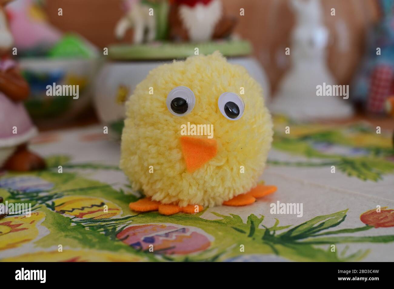 Yellow cute woolen easter biddy Stock Photo - Alamy