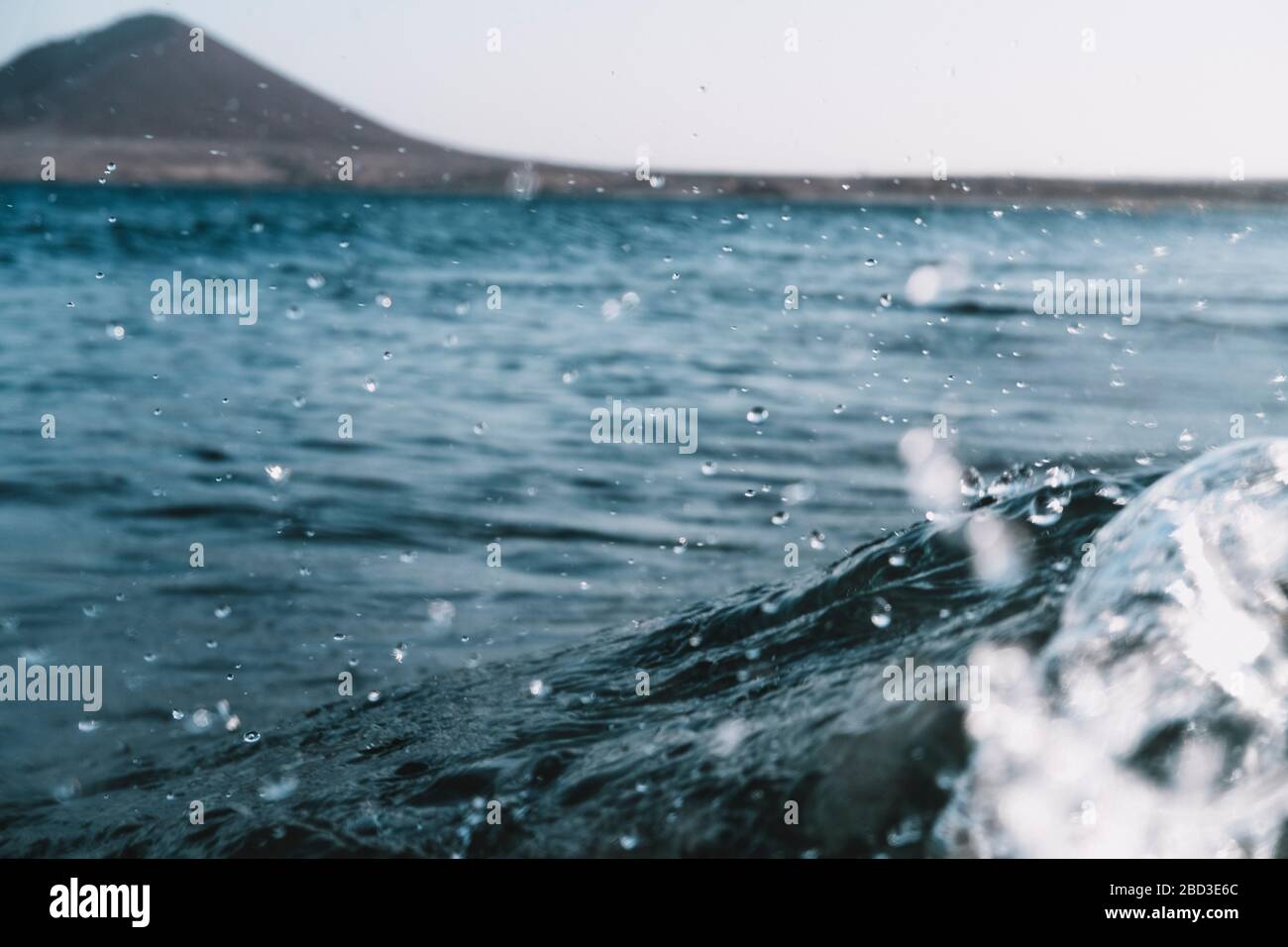Sea water drops over a small ocean wave Stock Photo - Alamy