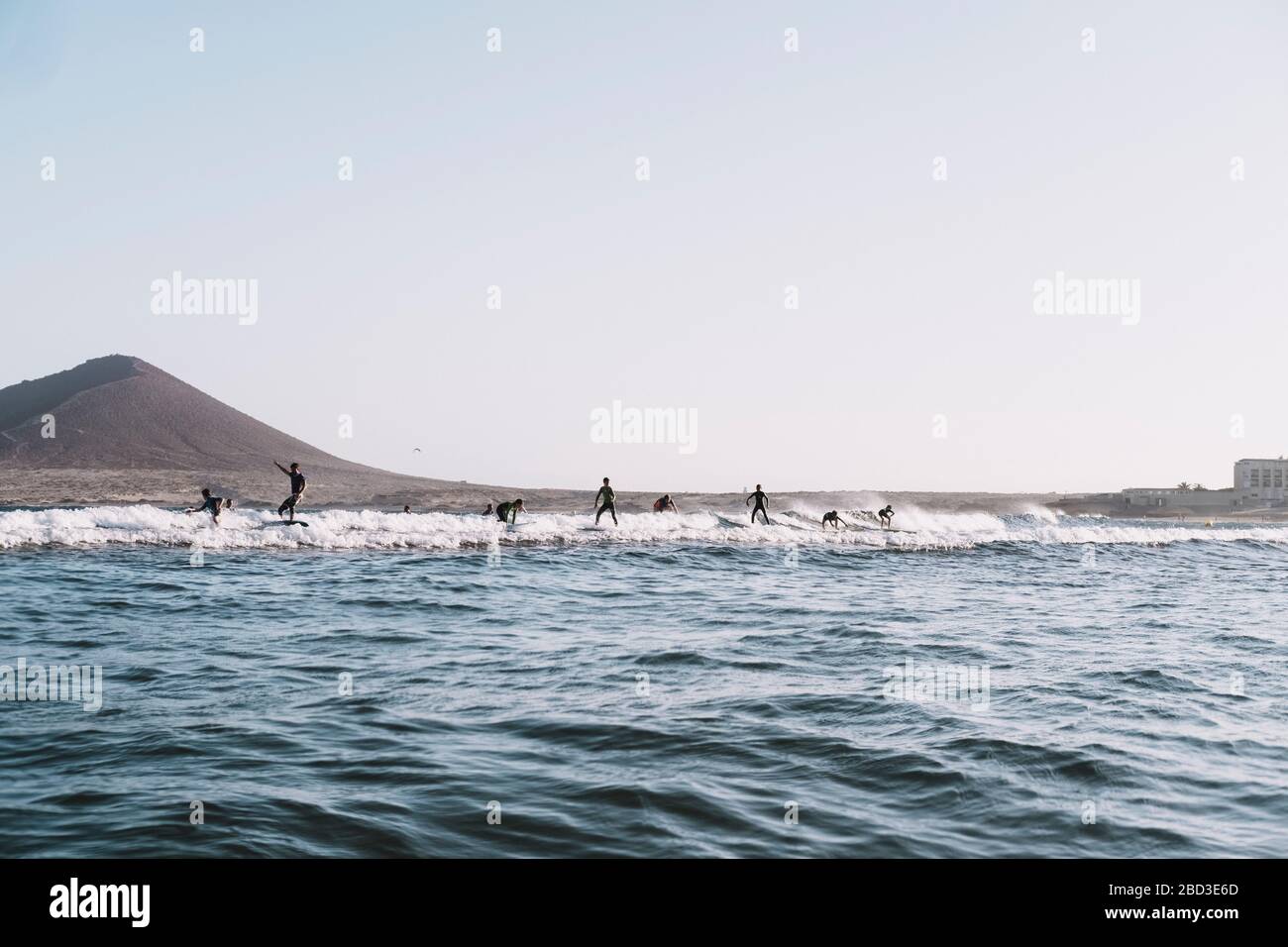 Surfers riding wave hi-res stock photography and images - Alamy