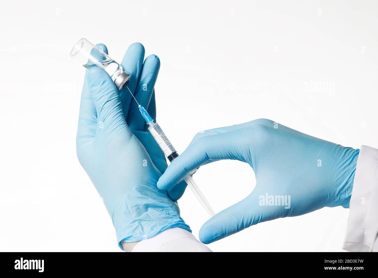 Close up doctor arm using syringe and ampoule on white background ...