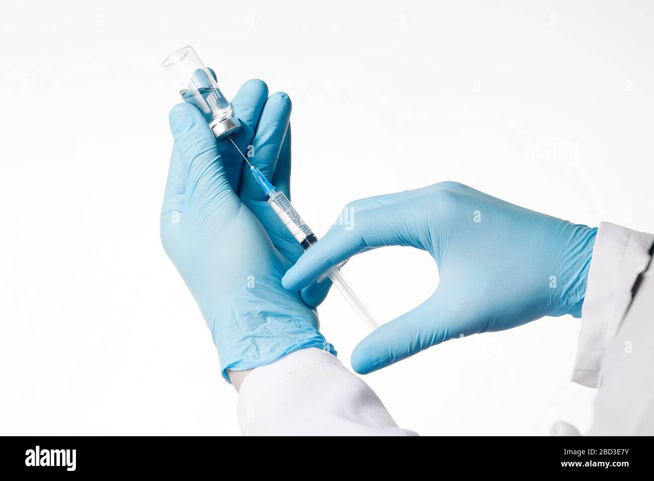 Close up doctor arm using syringe and ampoule on white background ...
