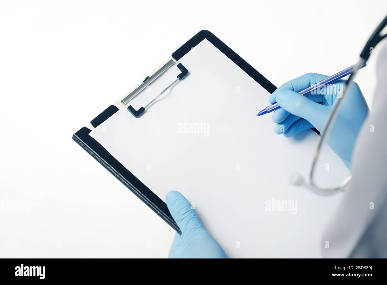 Doctor holding medical clipboard with empty blank sheet of paper and ...