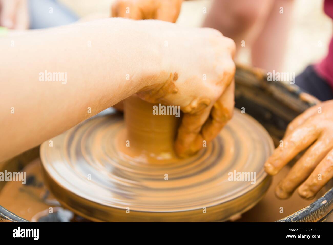 A close up view on ceramic production process on potter's wheel with ...