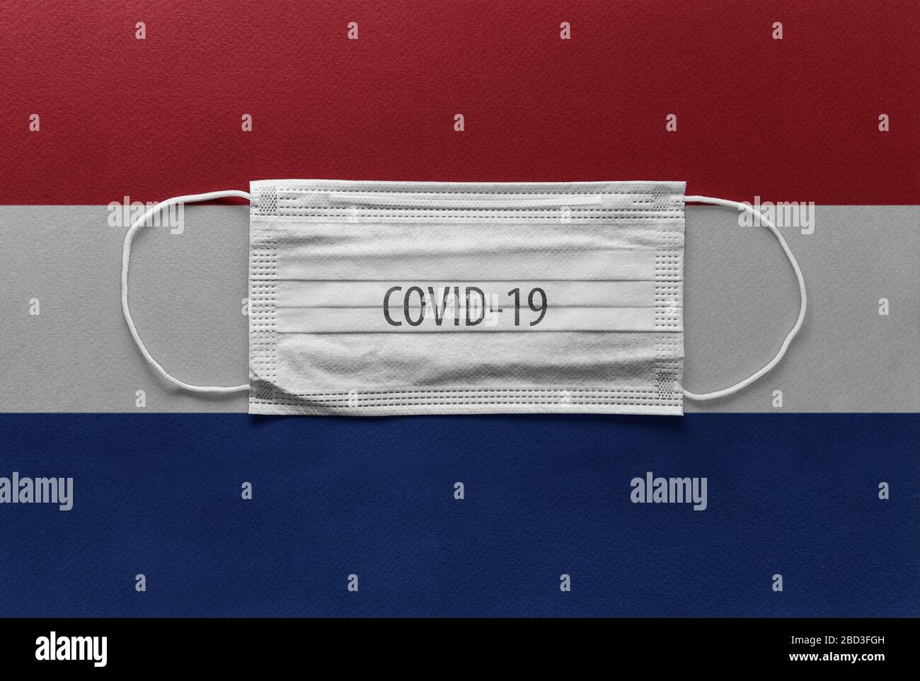 An individual face medical surgical mask on Netherlands national flag ...