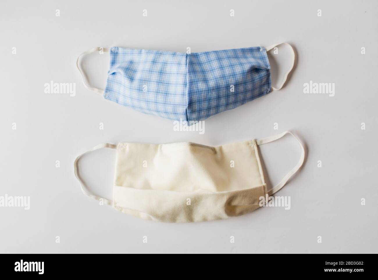 Homemade cloth face masks used during Covid-19 on white backdrop Stock ...