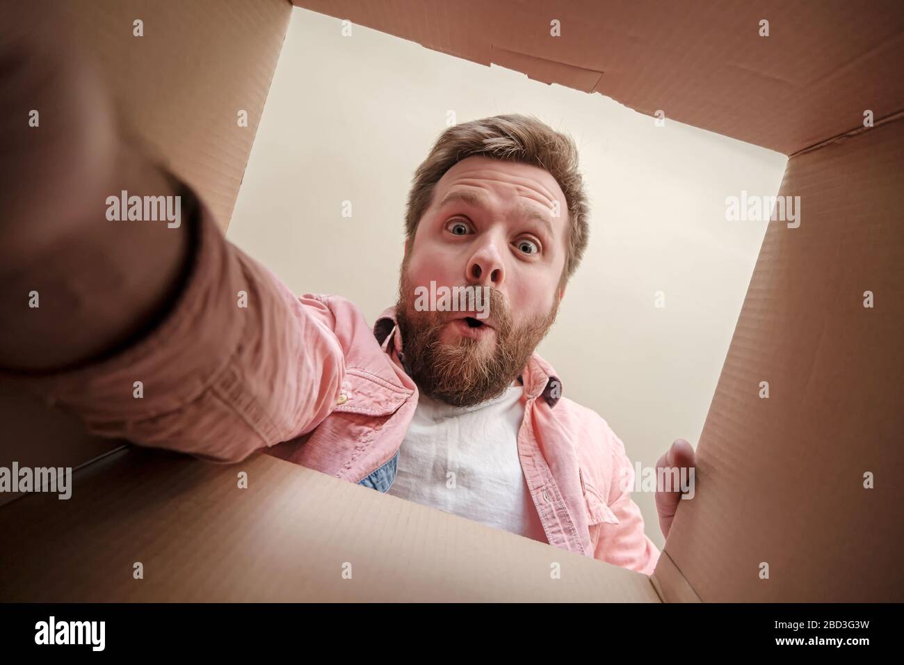 Satisfied, surprised man holds out his hand, trying to get a gift or ...