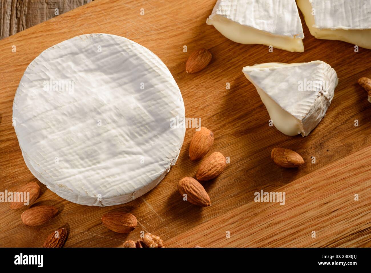 Whole wheel of Camembert cheese, pieces, almonds, walnuts Stock Photo ...