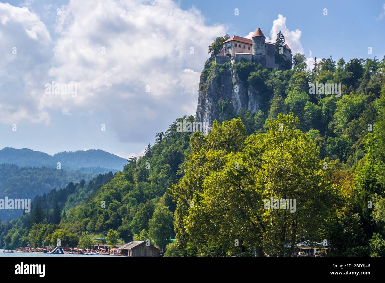 Medieval castle on the rock above the Lake Bled, Alpine mountains at ...