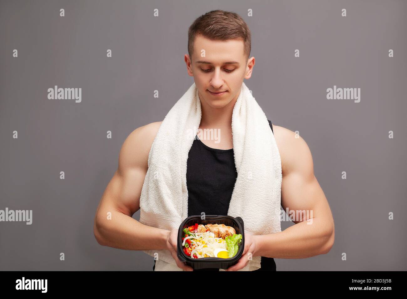 Strong man consumes a high-protein meal of meat and fruit Stock Photo ...