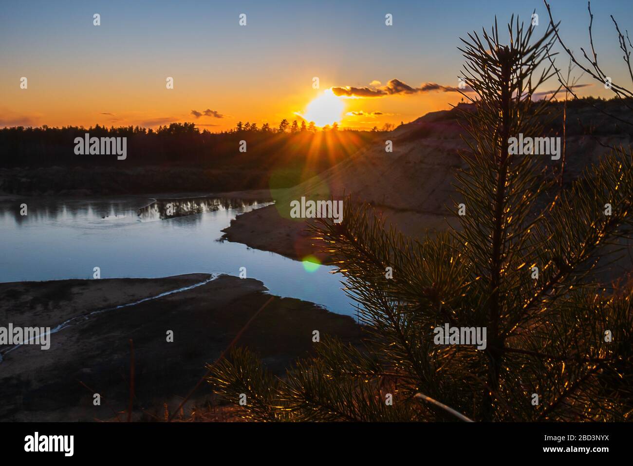 Trees and a lake in an old sandy quarry Stock Photo - Alamy