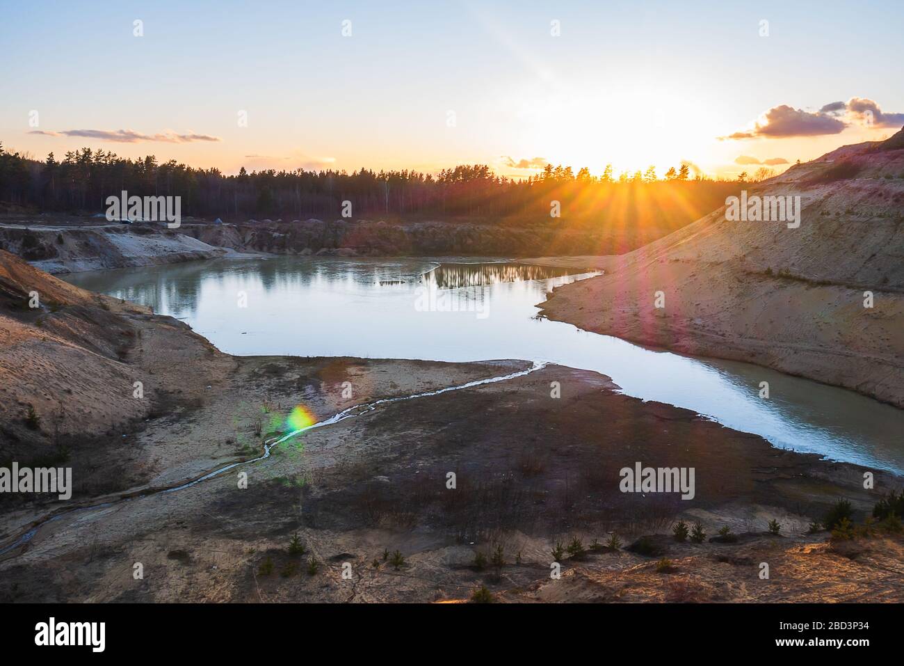 Trees and a lake in an old sandy quarry Stock Photo - Alamy