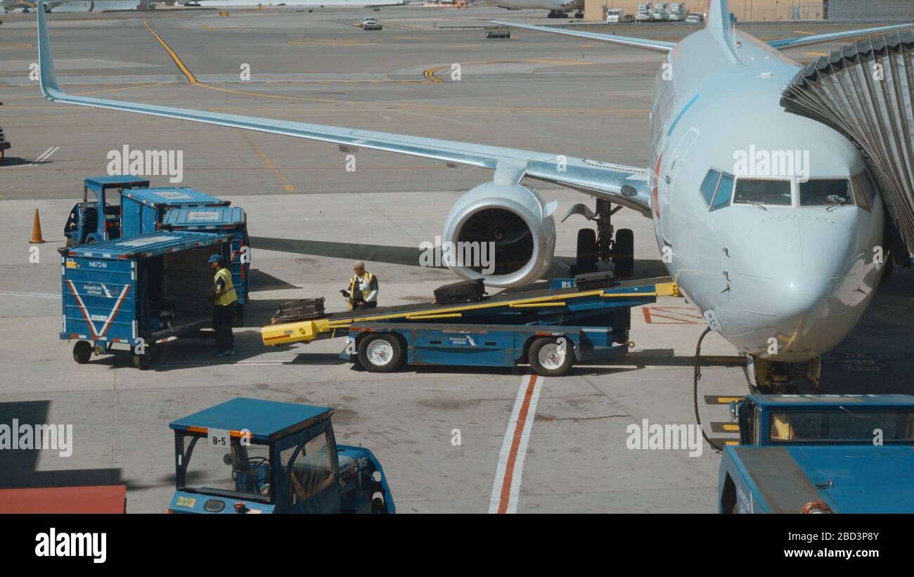 Loading baggage in an airplane - DALLAS, UNITED STATES - APRIL 23, 2017 ...