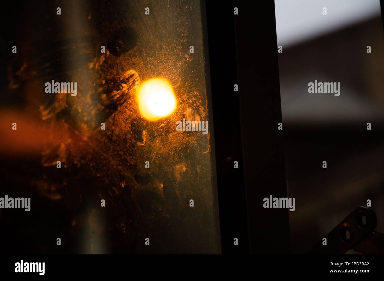 Abstract orange light ball reflection in dark black window Stock Photo ...