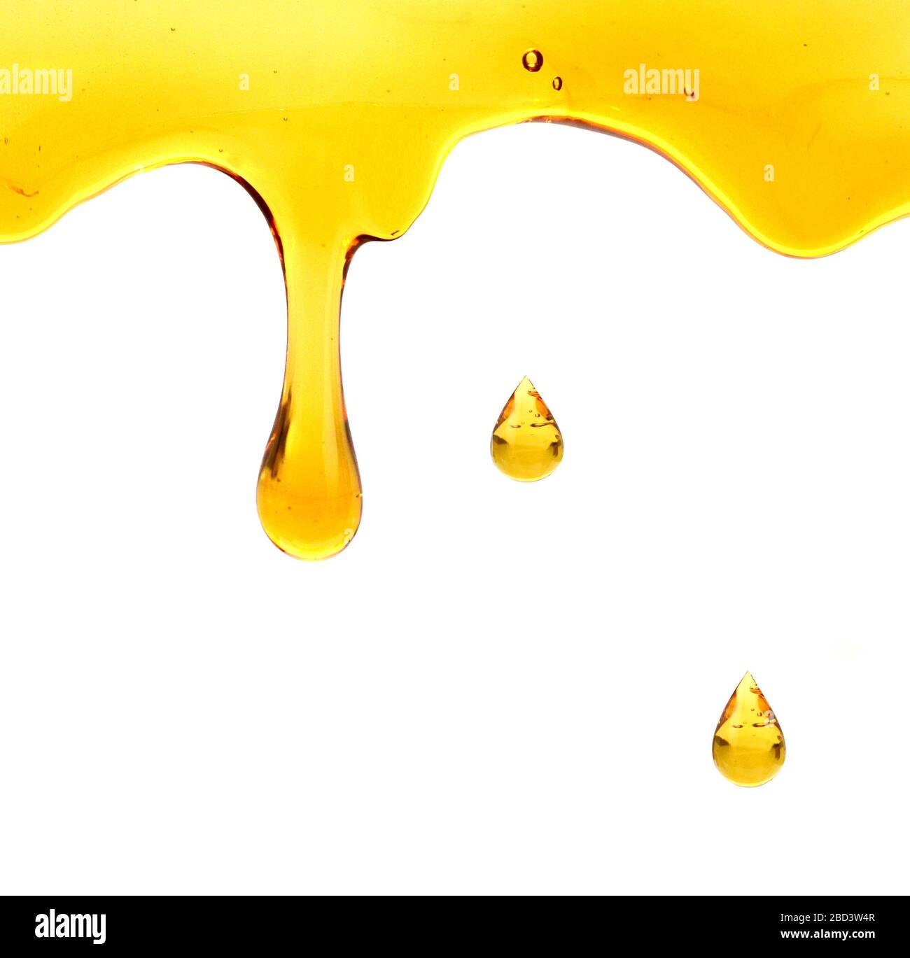 Closeup honey dripping isolated on white background Stock Photo - Alamy