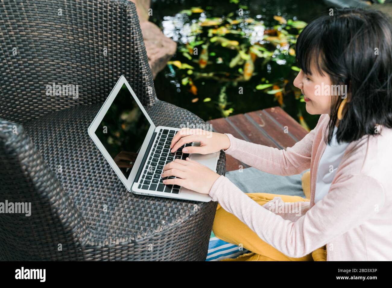 Young asian woman using laptop in garden with happy. Technology with ...
