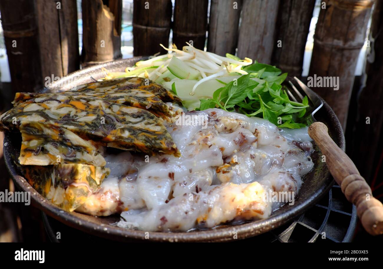 Homemade Vietnamese vegan food, black plate of steamed rice roll ...