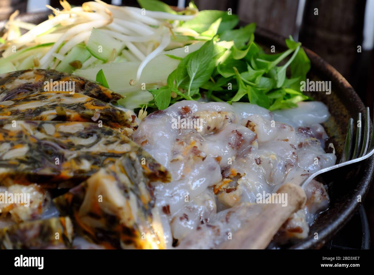 Homemade Vietnamese vegan food, black plate of steamed rice roll ...