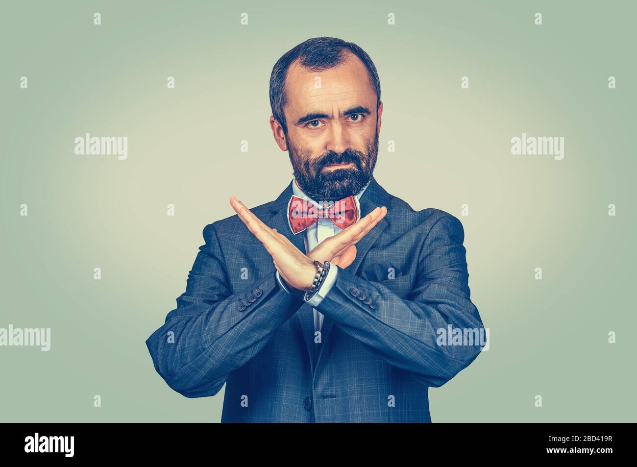 Mature man showing time out of hand gesture, looking annoyed and ...